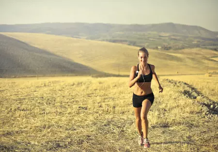 Cheerful Sportswoman Running Along Hill In Summer 3771112 1